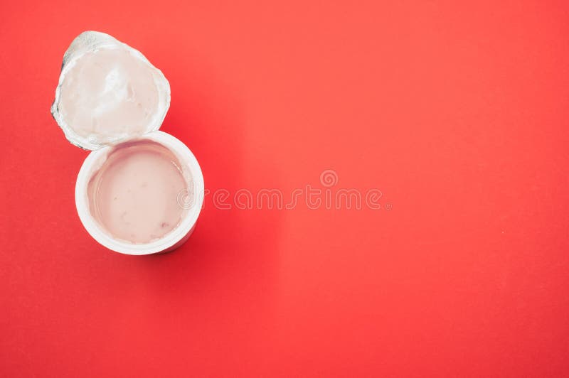 Top View of an Opened Plastic Container of Fruit Yogurt, on a Red ...