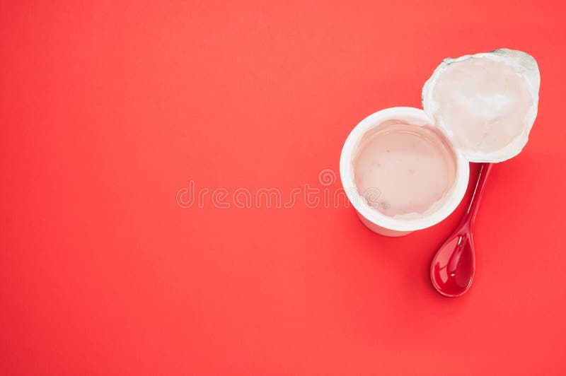 Top View of an Opened Plastic Container of Fruit Yogurt and a Spoon, on ...