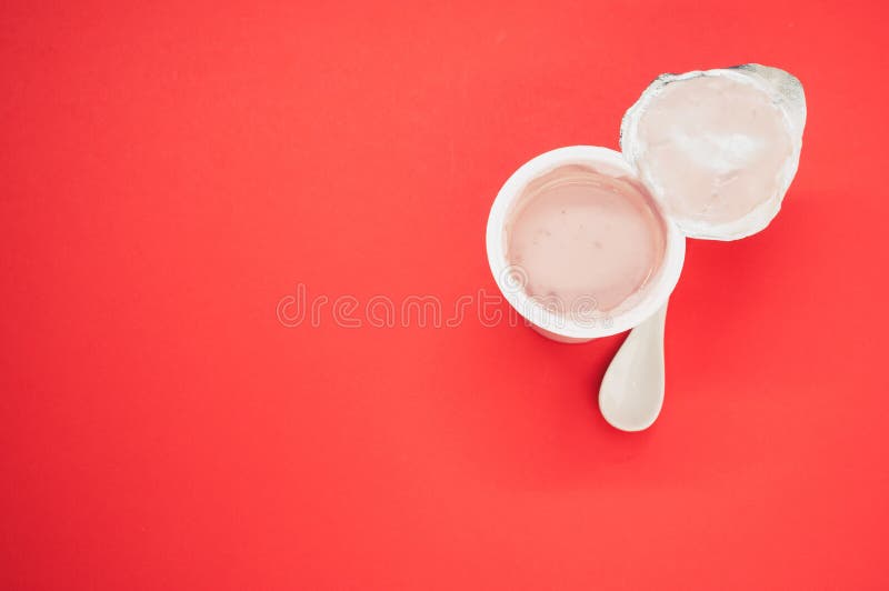 Top View of an Opened Plastic Container of Fruit Yogurt and a Spoon, on ...