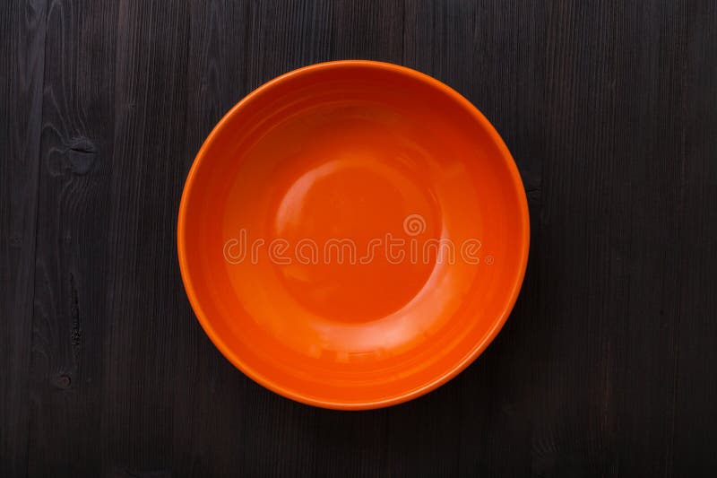Top View of Orange Bowl on Dark Brown Table Stock Image - Image of ...