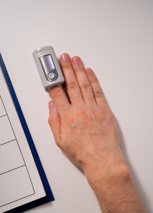 TOP VIEW: Oximeter. Man Using Digital Device To Monitor an Oxygen Level ...