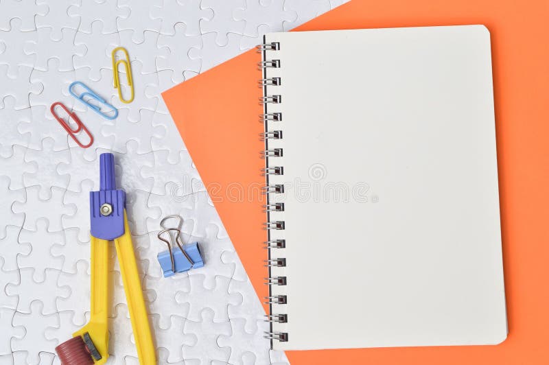 Top View of Paper Clips, Math Compass, Orange Paper and Notebook on the ...