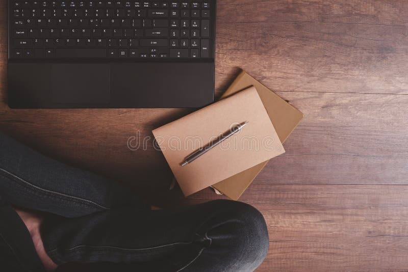 Top View of Pen on Notebook with Laptop and Woman Lap on Wooden Floor ...