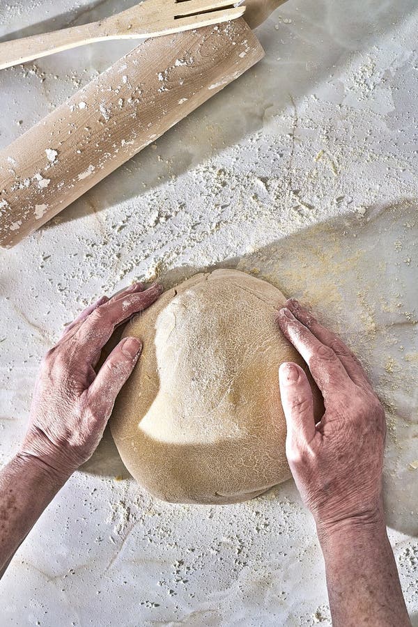 Top View of a Person Kneading a Dough with a Wooden Rolling Pin and ...