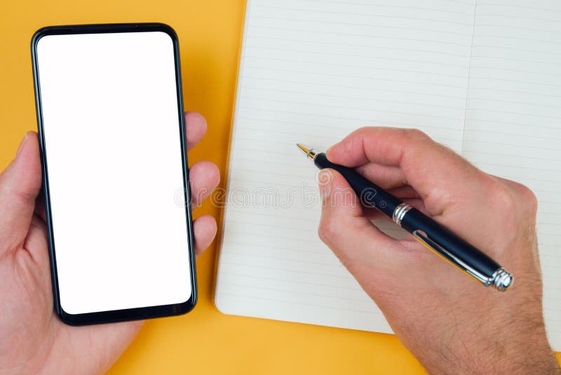 Top View of Person Taking Notes on Paper while Using Smartphone Stock ...
