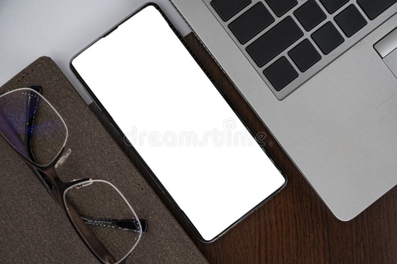 Top View of Phone on Table Near Laptop, Notepad and Glasses with White ...