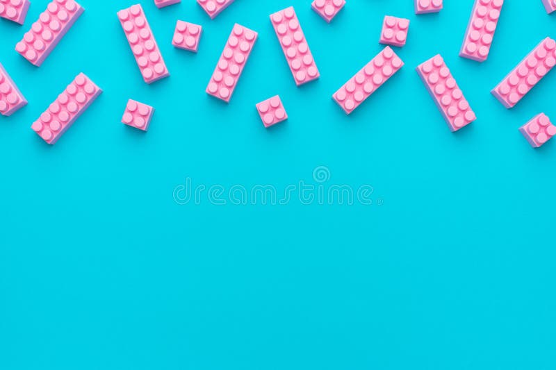 Pink Plastic Building Blocks on Turquoise Blue Background with Copy ...
