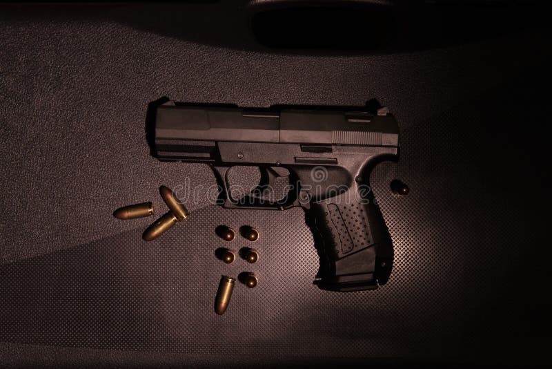 Top View of a Pistol with Bullets on a Dark Surface Stock Photo - Image ...