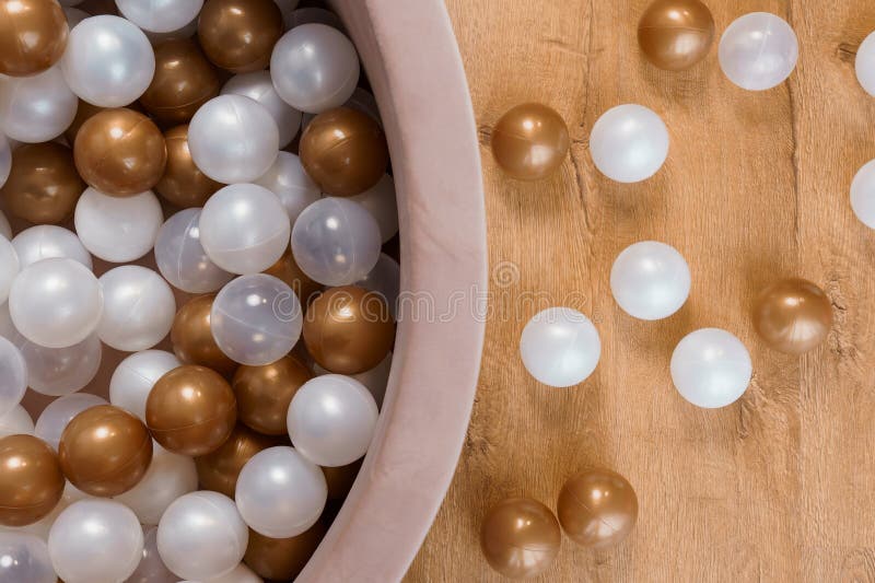 Top View of Plastic Balls Pit with Gold, White, and Translucent Spheres ...