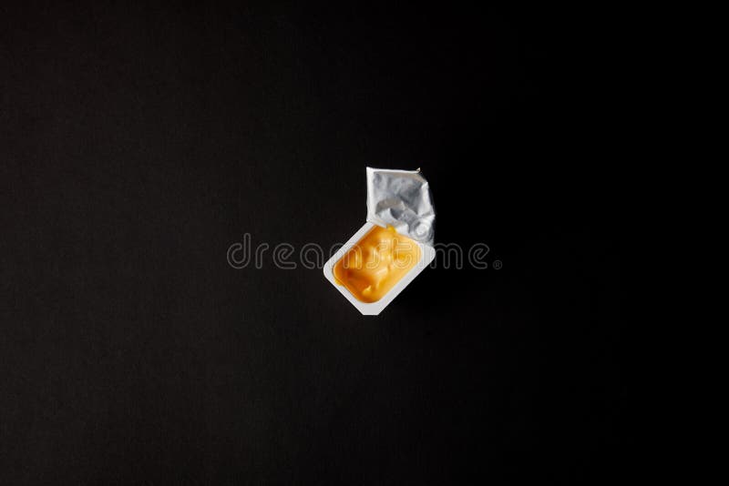 Top View of Plastic Container with Cheese Sauce Isolated on Black Stock ...