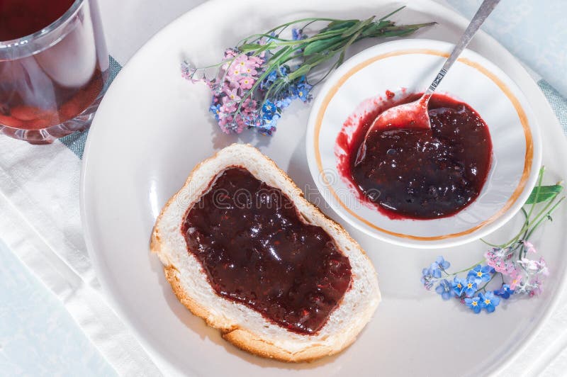 Top View of a Plate with Slice of Bun and a Blackcurrant Jam Socket ...