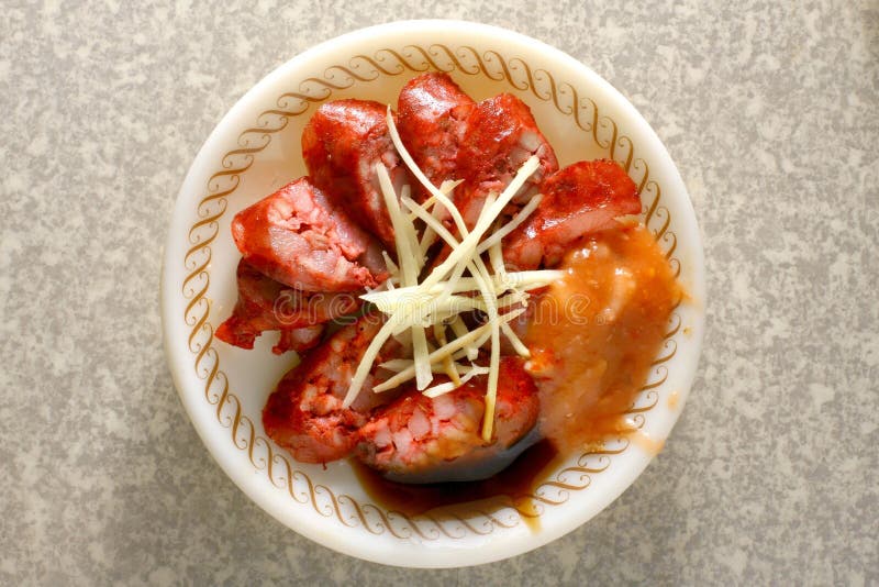 Top View of a Plate of Sliced Red Sausages Garnished with Ginger Strips ...