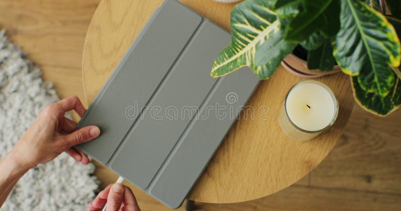 Top View. Plugging the Charging Cable in the Port of a Tablet Device To ...