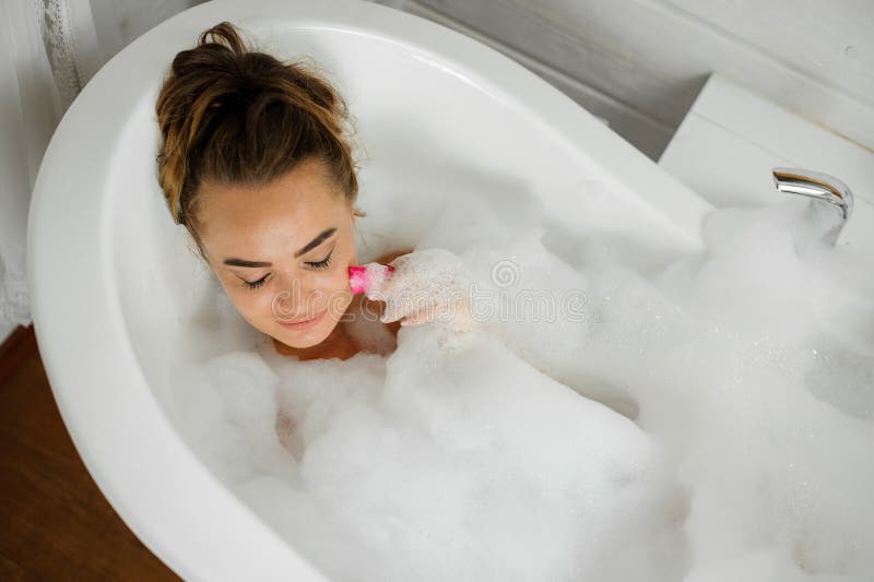 Top View Portrait Of Young And Beautiful Woman Lying In The Bath With