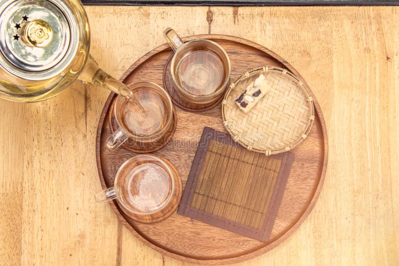 Top View Pour the Tea from the Kettle into a Cup of Tea on the Table ...