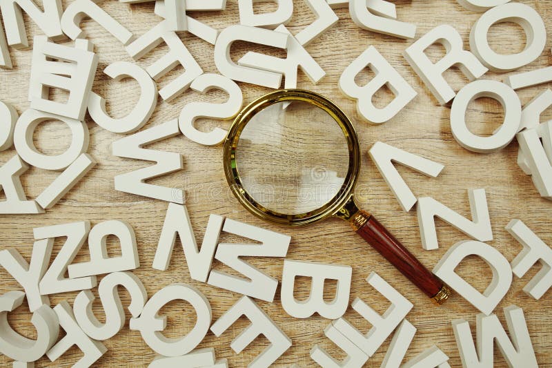 Top View Random Wooden Alphabet Letters with Magnifying Glass on Wooden ...