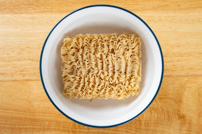 Raw Instant Noodles in a Bowl on a Wood Table Stock Photo - Image of ...