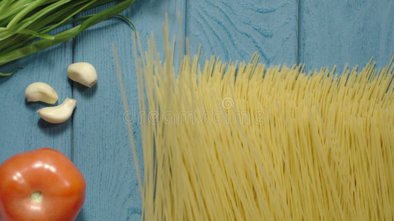 Top View: Raw Spaghetti Falling Down on the Blue Wooden Table Stock ...