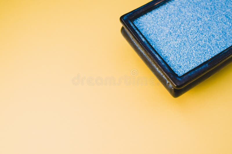 Top View of a Rectangular Box Filled with Small Blue Rocks on Yellow ...