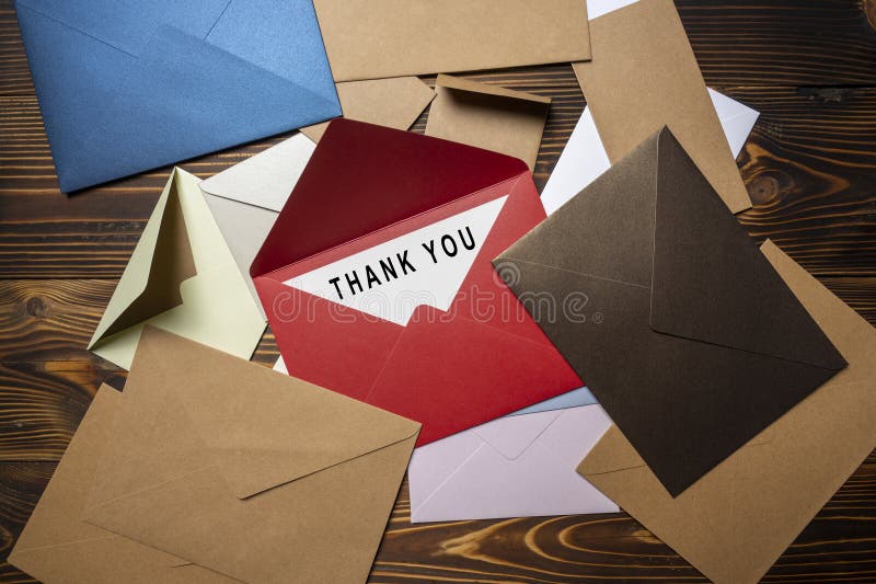 Top View of Red Envelope and Postcard with White Card with Words Thank ...