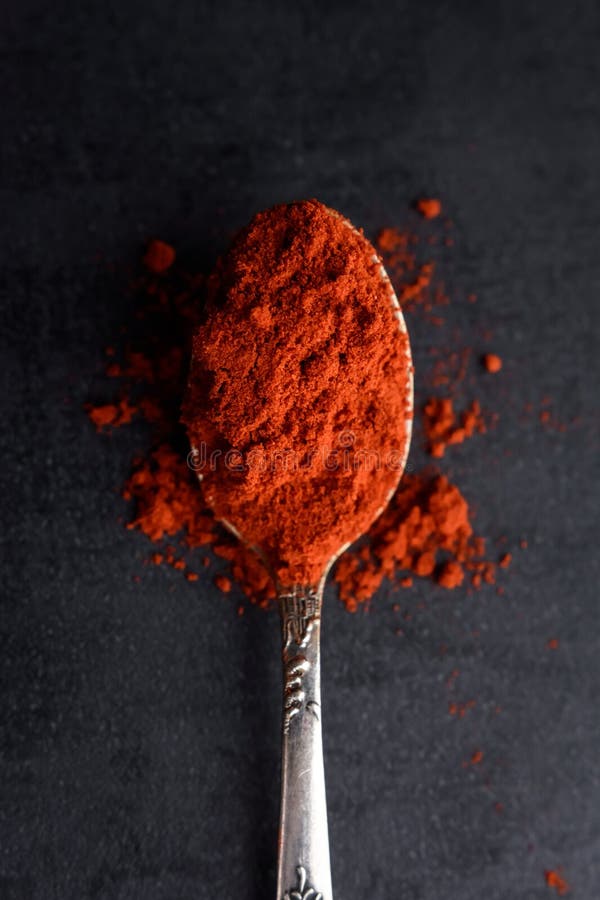 Top View of Red Paprika Powder in Spoon on Black Background with Copy ...