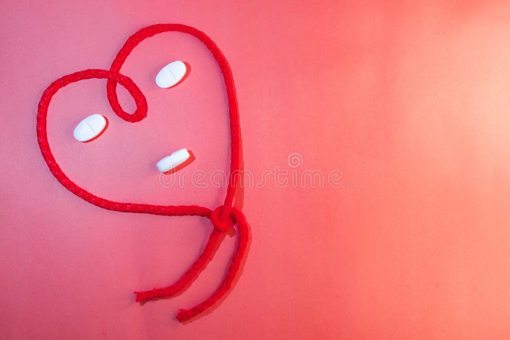 Top View of Red String in the Shape of a Heart Simulating a Face. Copy ...
