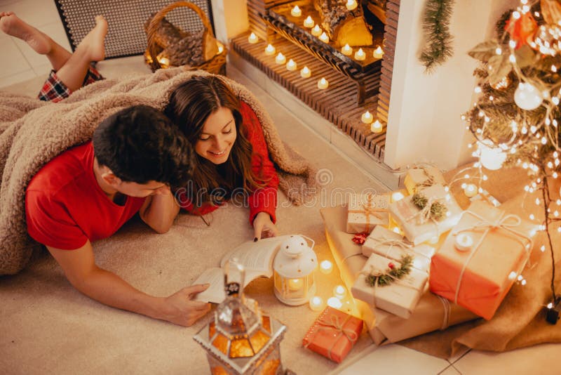 Top View Of Relaxing Couple Covered By A Soft And Cozy Blanket At Home