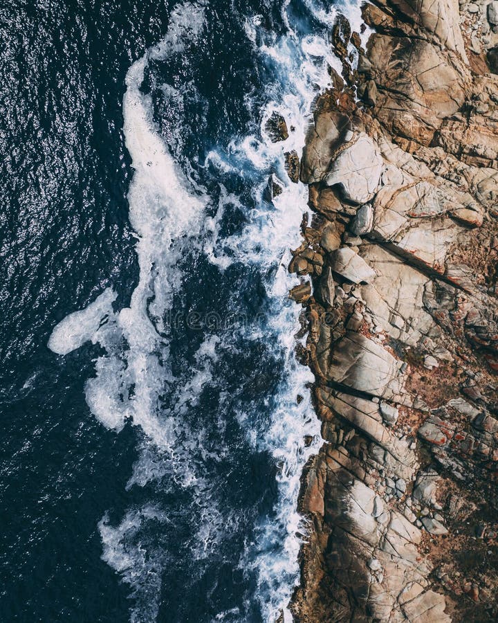 Top View of a Rocky Shoreline with Waves Hitting the Rocks Stock Photo ...