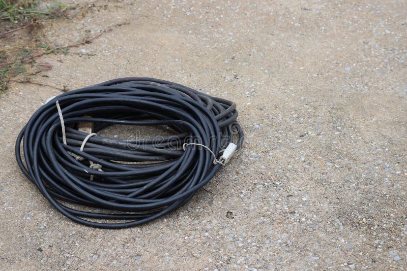 Top View of a Roll of Black Plastic Cables Laid on an Outdoor Road ...