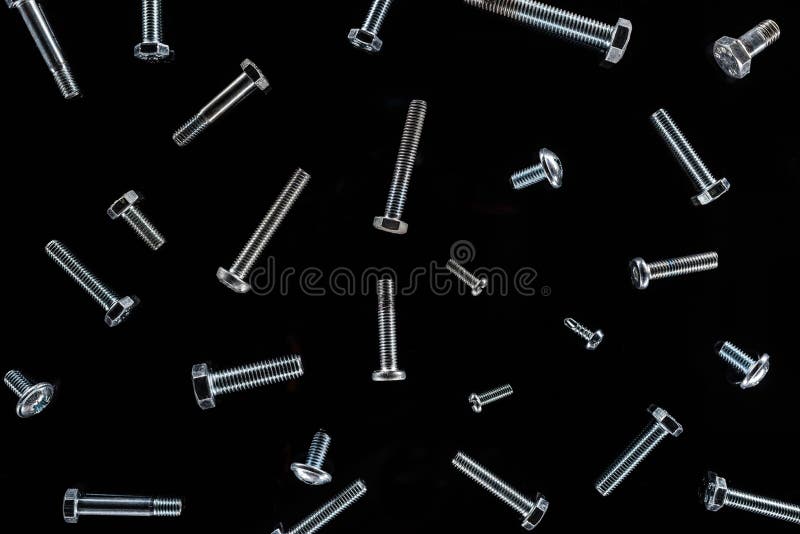 Top View of Scattered Metal Bolts Pattern Isolated on Black. Stock ...