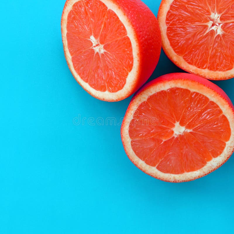 Top View of a Several Grapefruit Slices on Bright Background in Blue ...