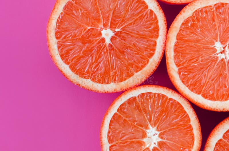Top View of a Several Grapefruit Slices on Bright Background in Purple ...