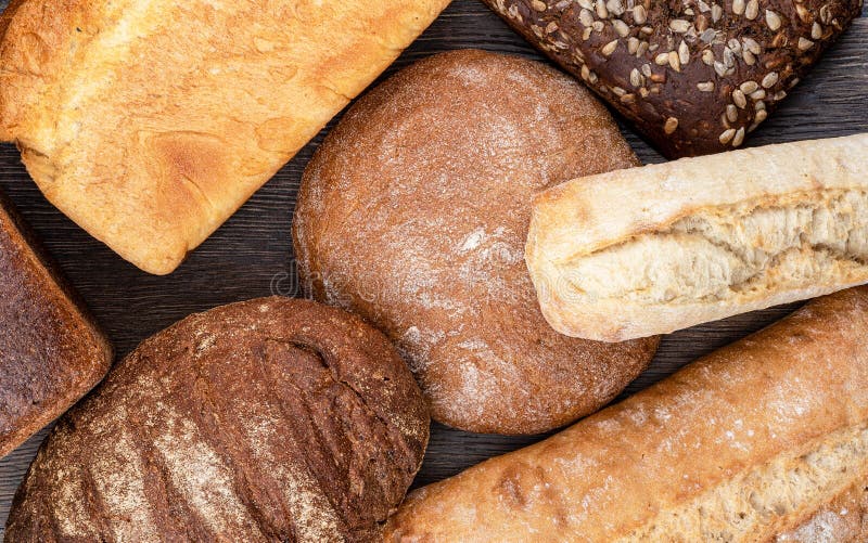 Top View of Several Loaves of Bread Over a Wooden Background Stock ...