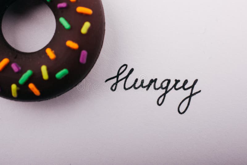 Top View Shot of a Donut Next To a Hungry Text - Concept of Hunger ...
