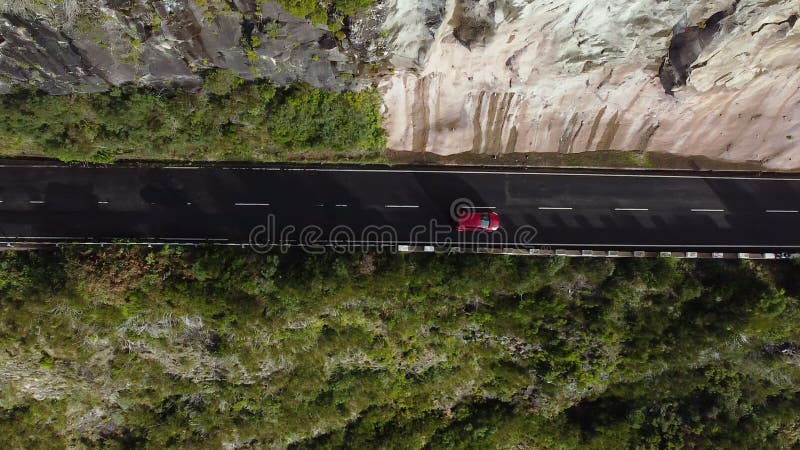Top View of a Single Car Driving on a Highway between Rocks and ...