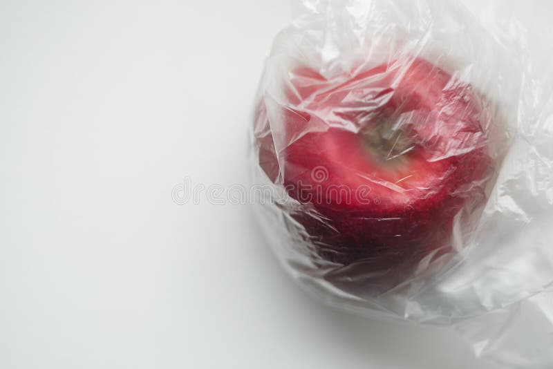 Top View of Single Red Apple Wrapped in a Transparent Plastic Bag Stock ...
