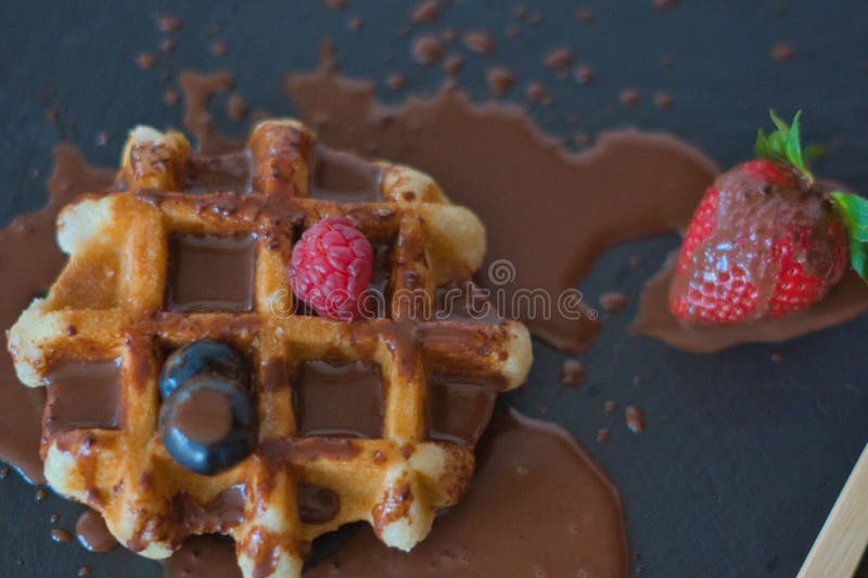 Top View of a Single Waffle with Chocolate, Berries and a Spoon on the ...
