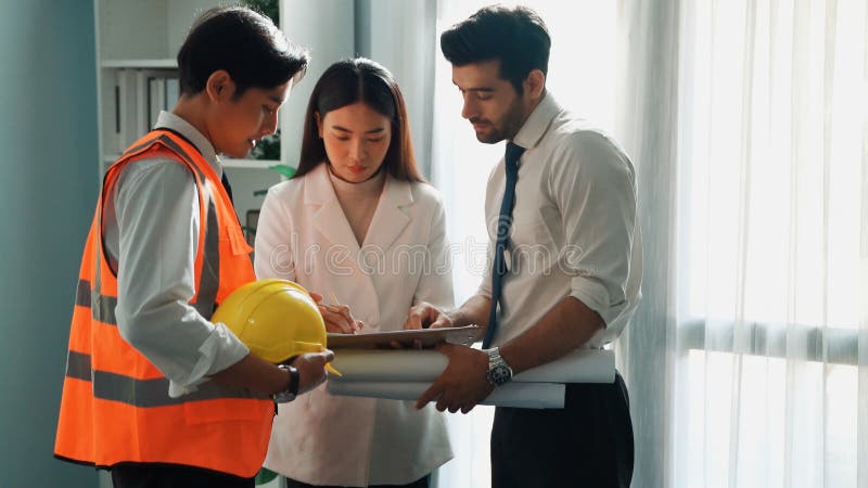 Top View of Skilled Engineer Team Looking at Blueprint Together ...