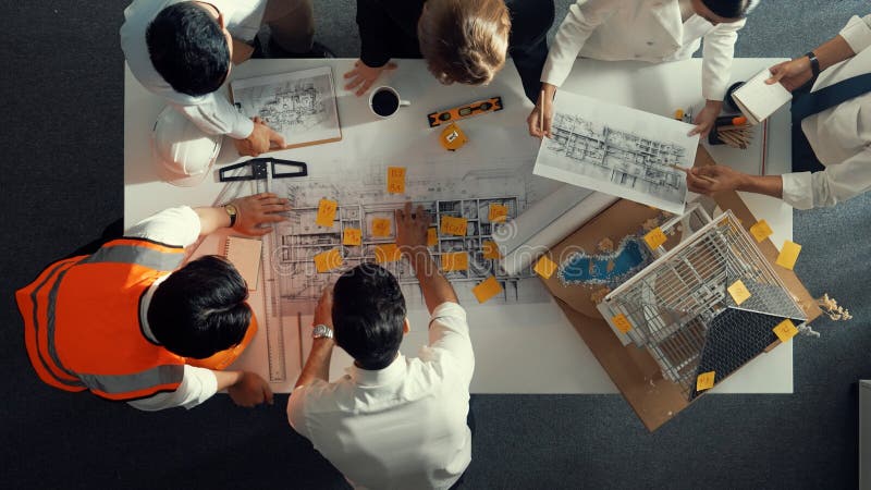 Top View of Skilled Engineer Team Talking while Looking at Plan ...