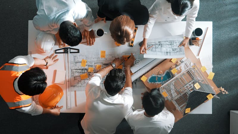 Top View of Skilled Engineer Team Talking while Looking at Plan ...