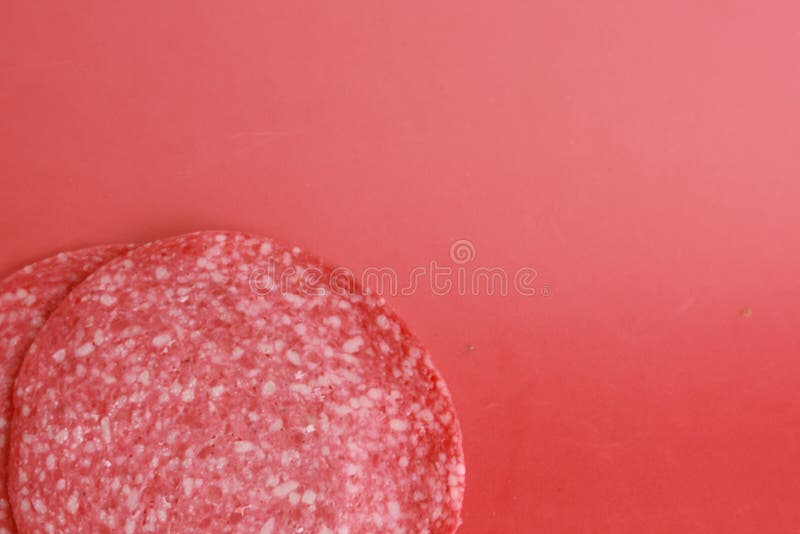 Top View of Sliced Salami Under the Lights Against a Pink Background ...