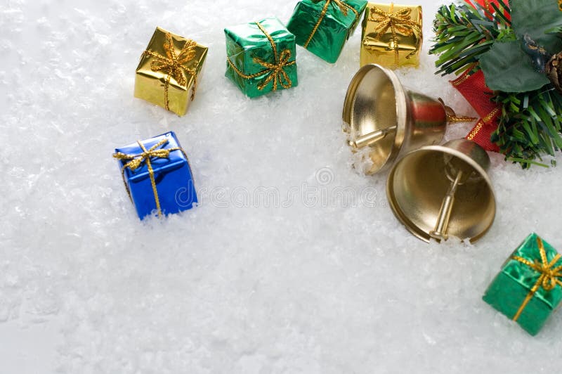 Top View of Small Christmas Gifts and Bells on Artificial Snow Stock ...