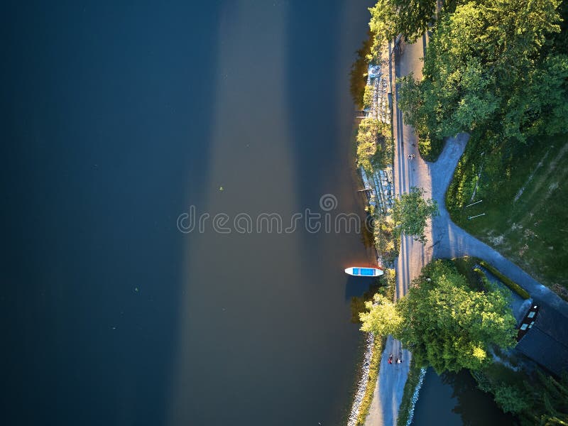 Top View of a Small Lake and Green Trees Around with a Small Path or ...