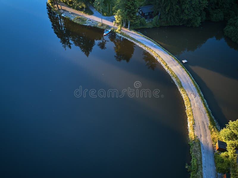 Top View of a Small Lake and Green Trees Around with a Small Path or ...