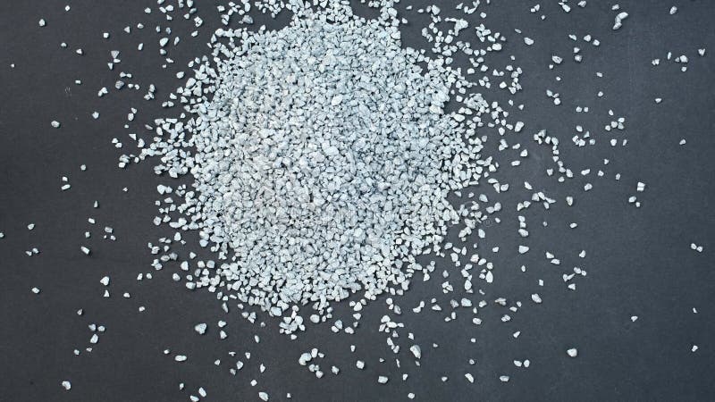 Silver Granules Falling into a Pile on Dark Gray Background Stock ...