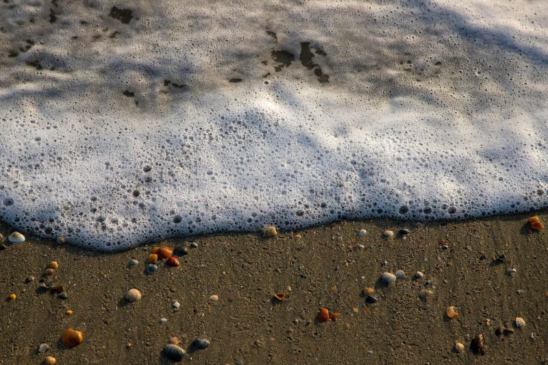 A Top View of a Small Wave with Foam on the Sand Stock Photo - Image of ...