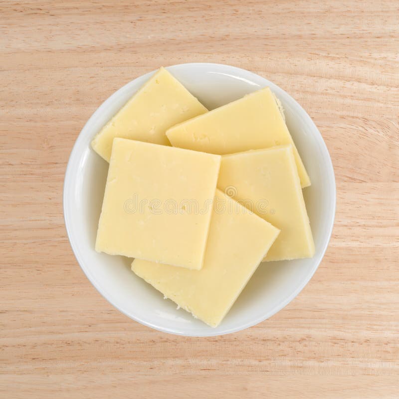 Sharp Cheddar Cheese in a Small Bowl Stock Photo - Image of squares ...