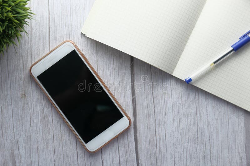 Top View of Smart Phone and Notepad on Table Stock Image - Image of ...