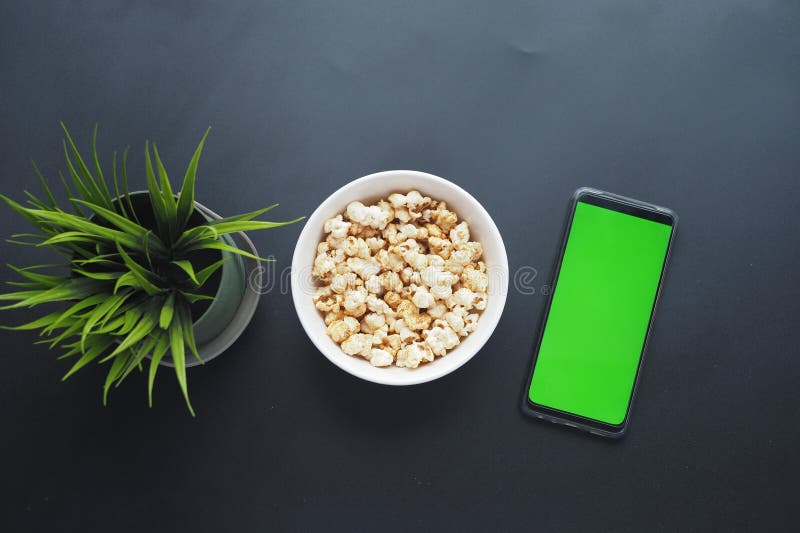 Top View of Smart Phone and Popcorn on Black Background Stock Photo ...