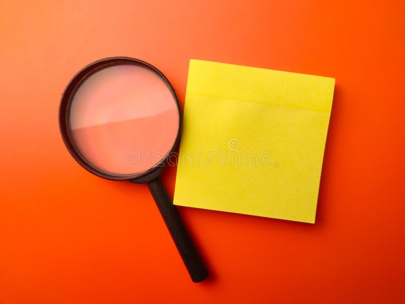 Top View Sticky Note and Magnifying Glass on a Orange Background Stock ...